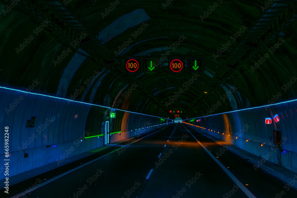 Illuminated signs of maximum speed allowed 100 km/h inside a highway ...