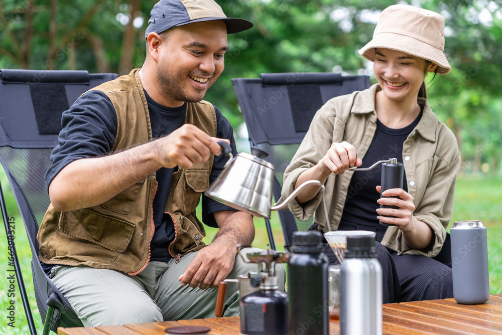Happy asian couple making drip coffee together at camp side, They ...
