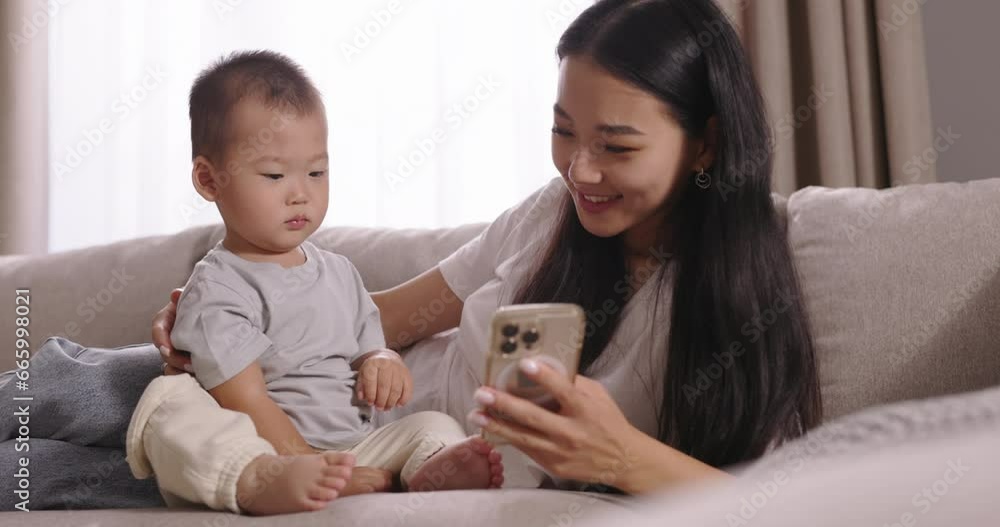 Asian mom and toddler spending time together. Multiethnic asian family ...