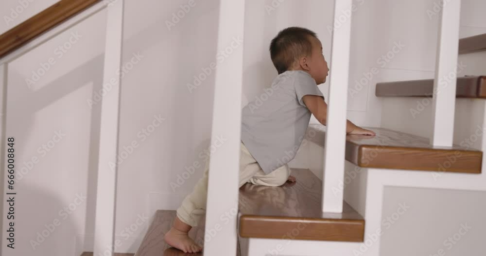 Baby boy crawling up stairs. Small brave bold independent skillful ...