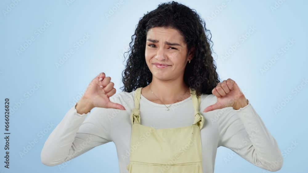 Thumbs down, face and woman in studio with hands for rejection of bad ...
