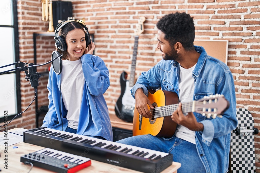 Man and woman musicians playing classical guitar singing song at music ...