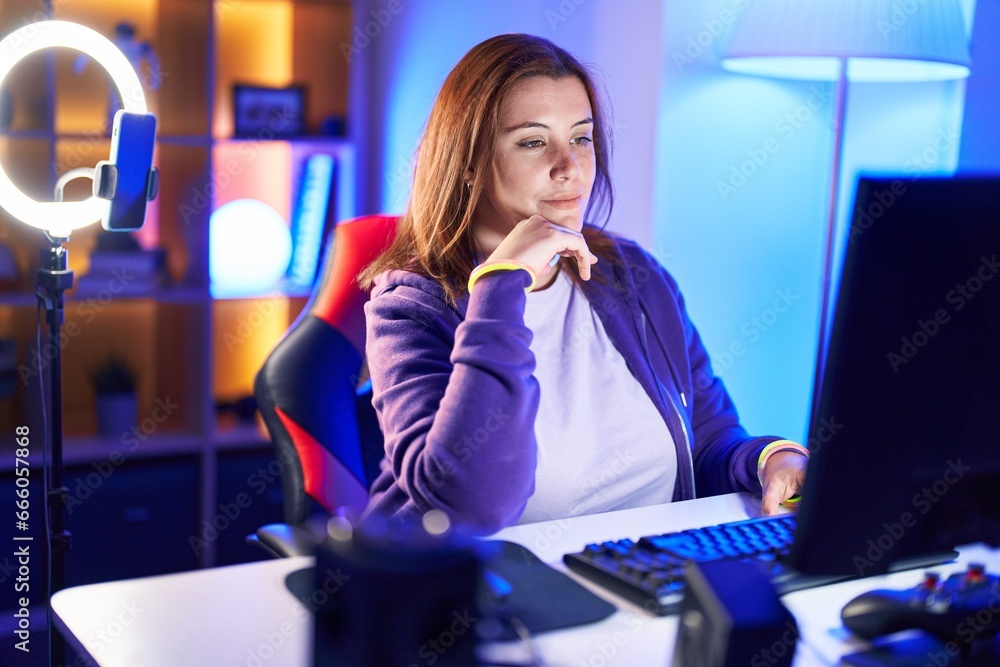 Young beautiful plus size woman streamer playing video game using ...