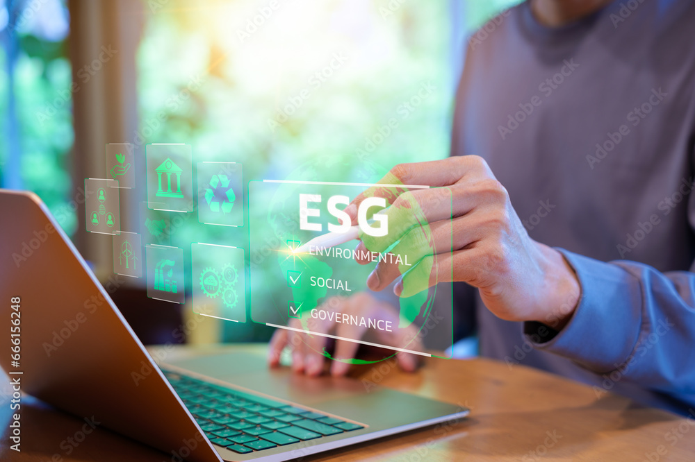 ESG environmental social governance investment business concept. Businessman using a computer ...
