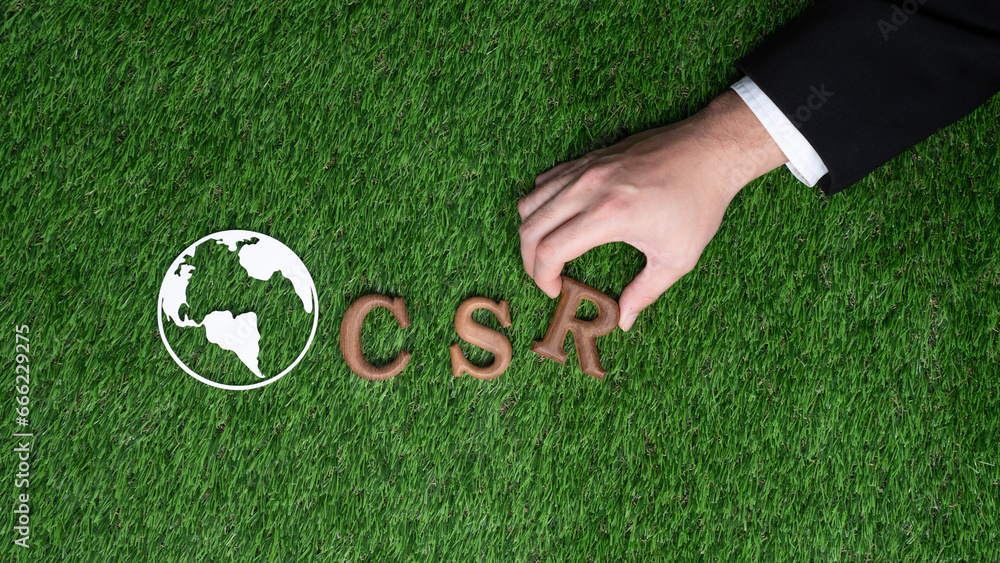 Hand arrange wooden alphabet text in CSR on biophilic background with ...