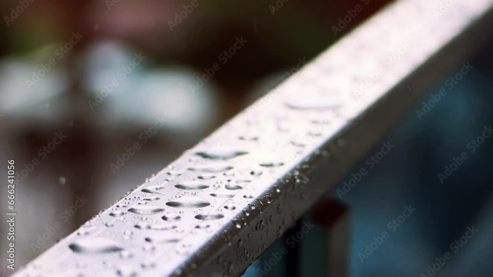 Rain dropping on railing. Close-up of rain drops falling on balcony ...