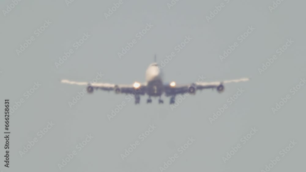 Jet airliner landing overhead. Front bottom view on landing airplane ...