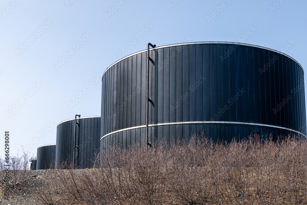 Large black metal fuel storage tanks at a petrochemical plant for bulk ...