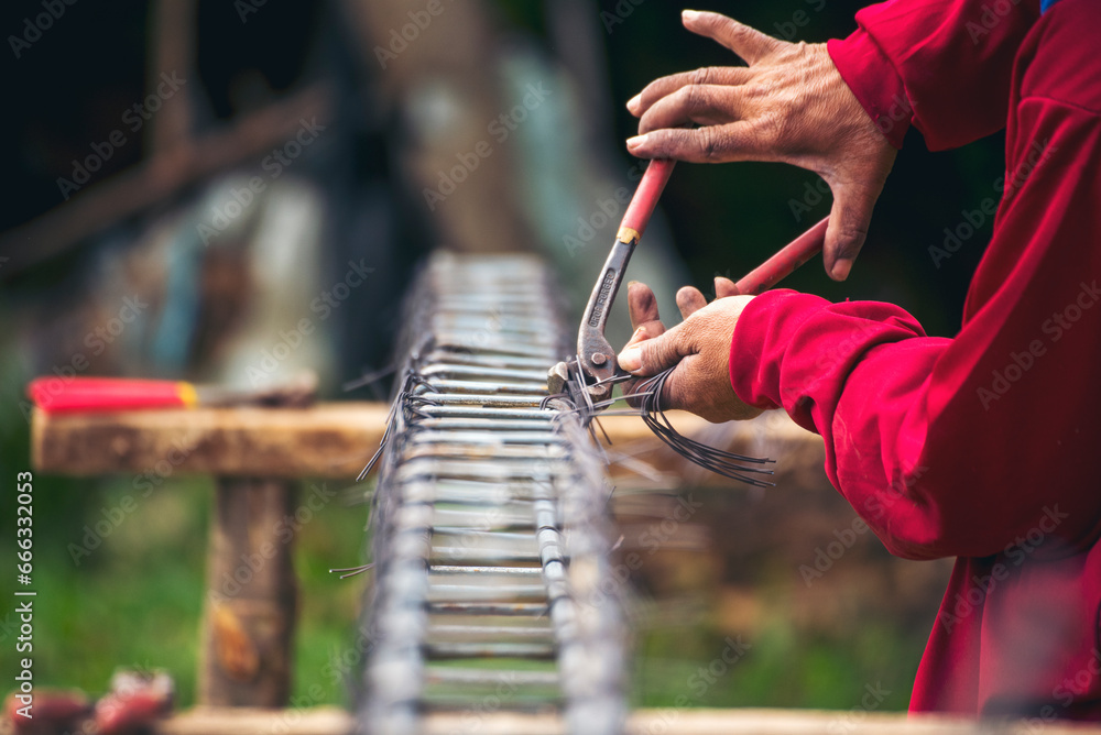 Construction Worker hands using pincer pliers iron wire. Outdoor Worker ...