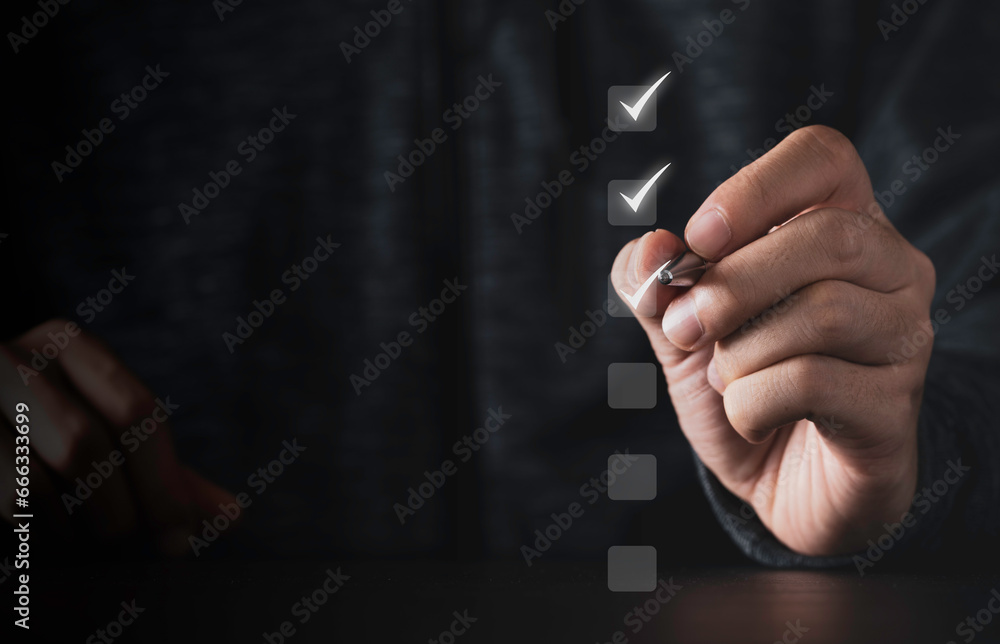 Businessman using pen to tick correct sign mark on checklist for ...