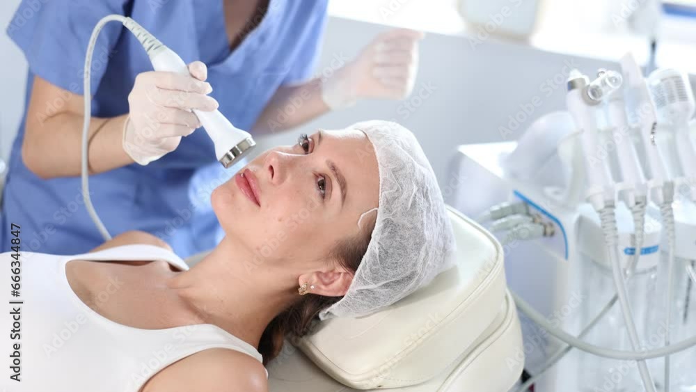 Young female patient receiving facial procedure with high frequency ...