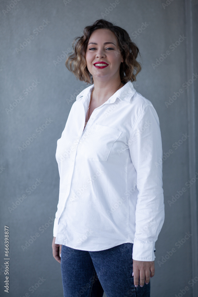 Beautiful fat woman posing against grey wall. The plus size model ...