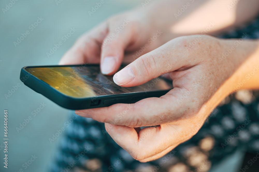 Woman browsing through photo gallery on her personal smartphone device ...
