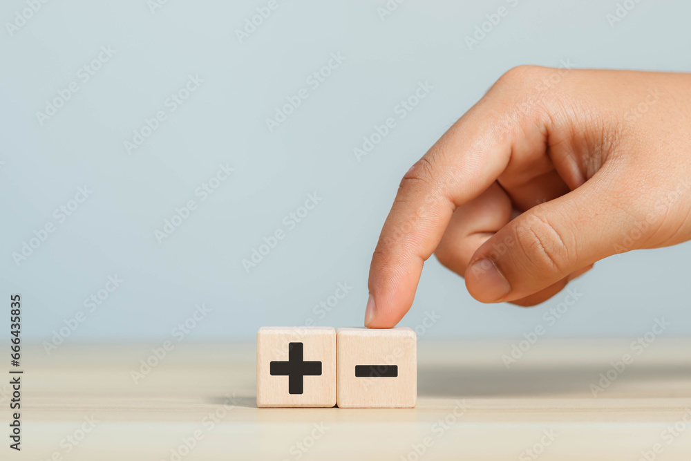 Wooden blocks showing plus and minus signs. The concept of opposites ...