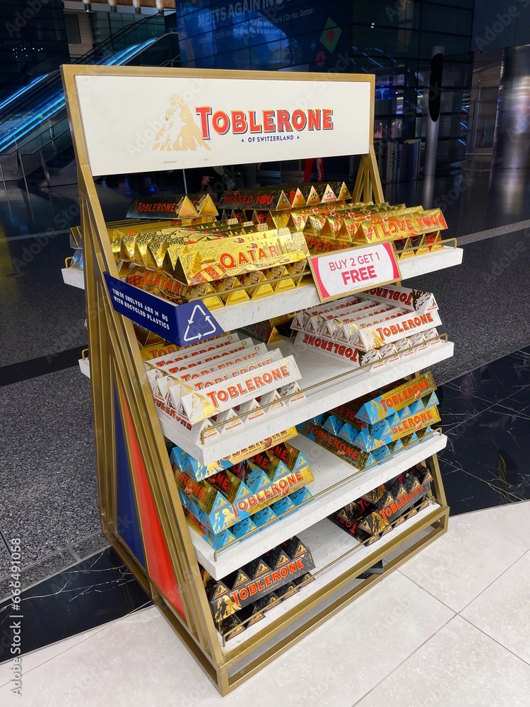 Rack with Toblerone products. Bright red logo. Famous trademark. Swiss ...