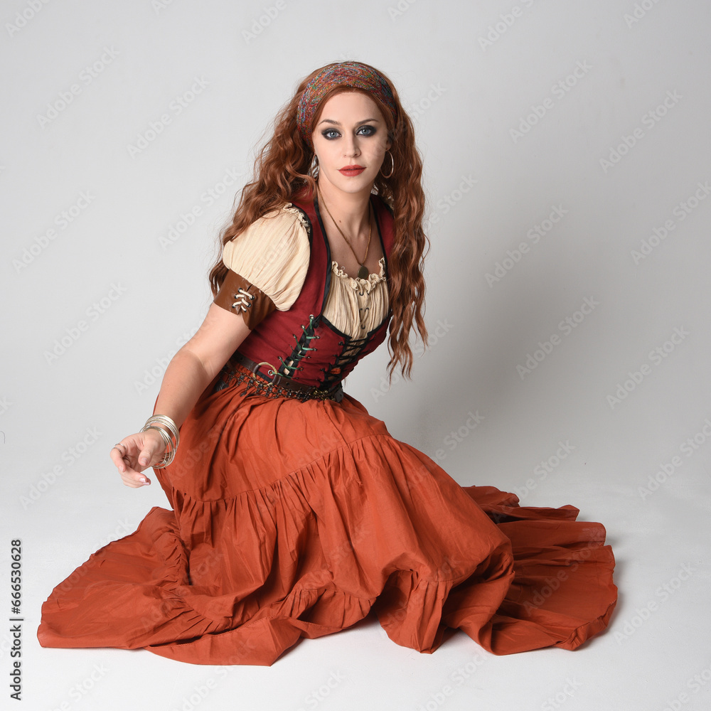 Full length portrait of beautiful red haired woman wearing a medieval ...