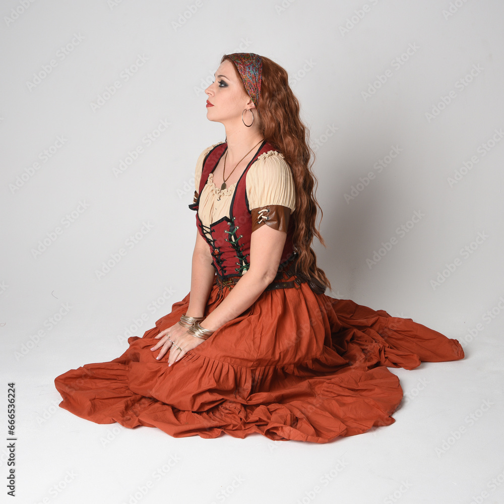 Full length portrait of beautiful red haired woman wearing a medieval ...