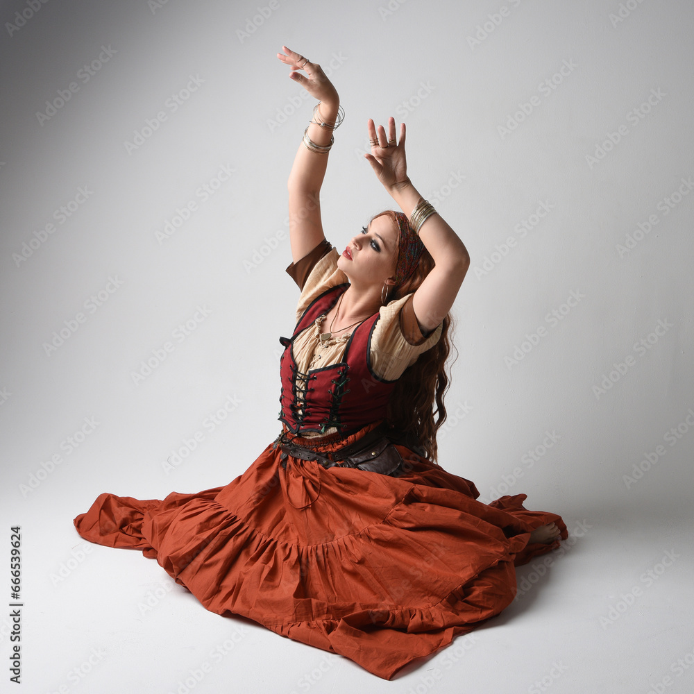 Full length portrait of beautiful red haired woman wearing a medieval ...