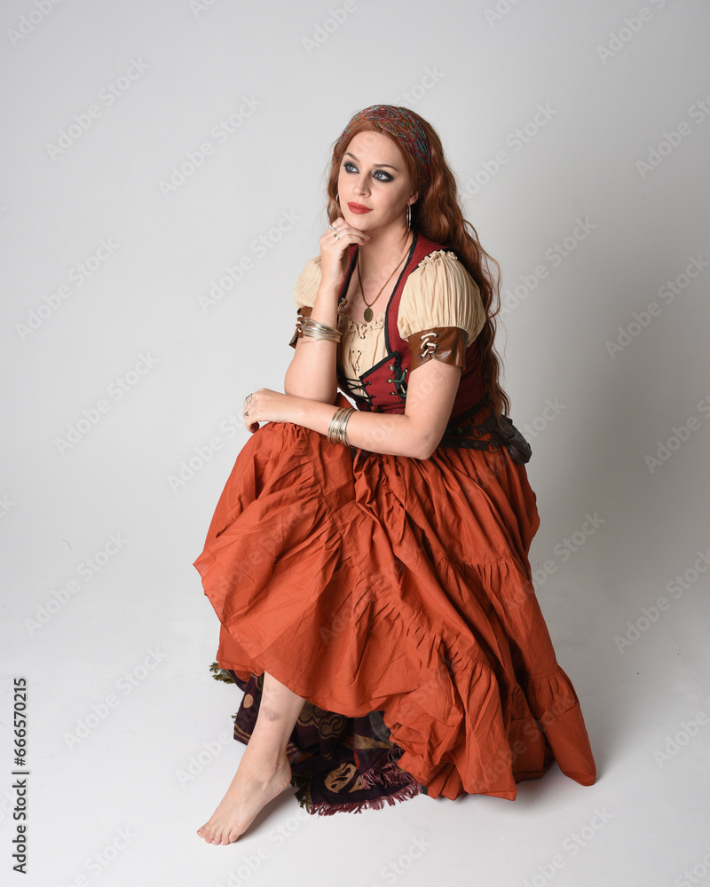 Full length portrait of beautiful red haired woman wearing a medieval ...