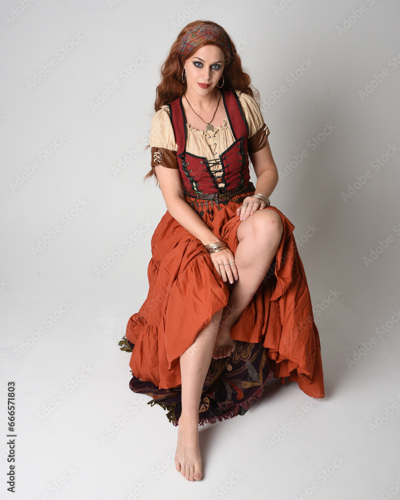 Full length portrait of beautiful red haired woman wearing a medieval ...