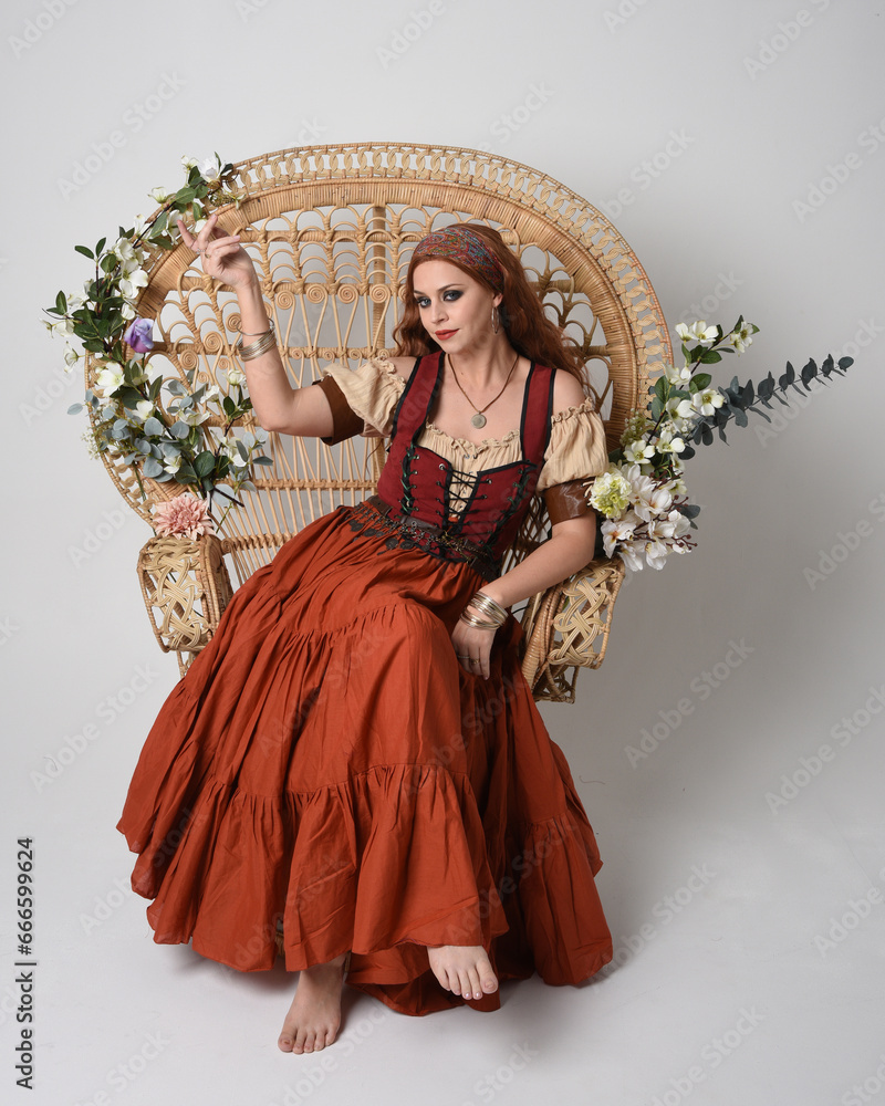Full length portrait of beautiful red haired woman wearing a medieval ...