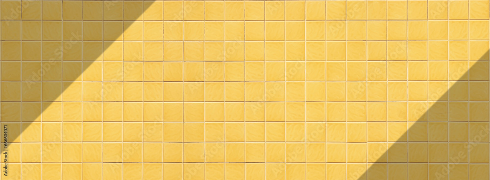 Yellow square tile wall background with sunlight and shadow on surface ...