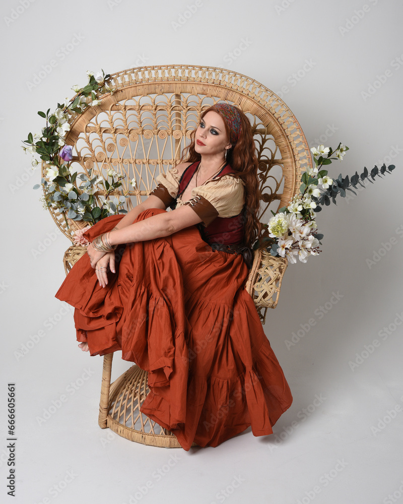 Full length portrait of beautiful red haired woman wearing a medieval ...