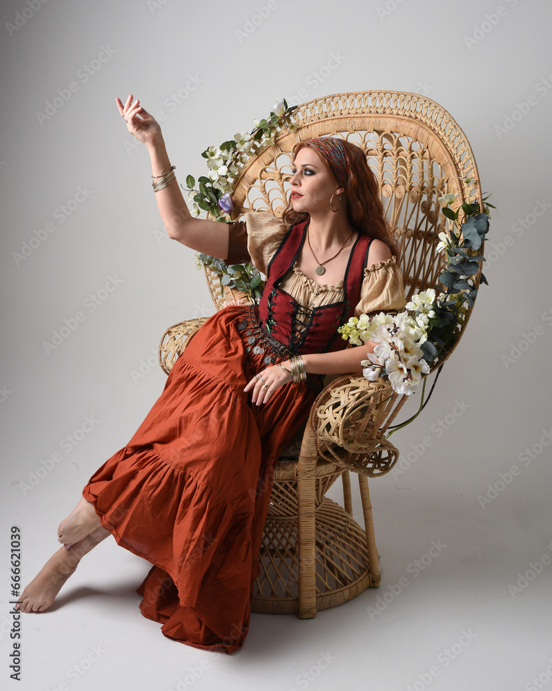 Full length portrait of beautiful red haired woman wearing a medieval ...