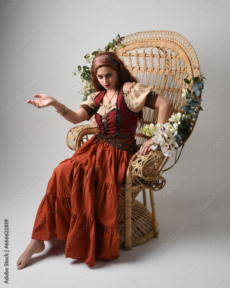Full length portrait of beautiful red haired woman wearing a medieval ...