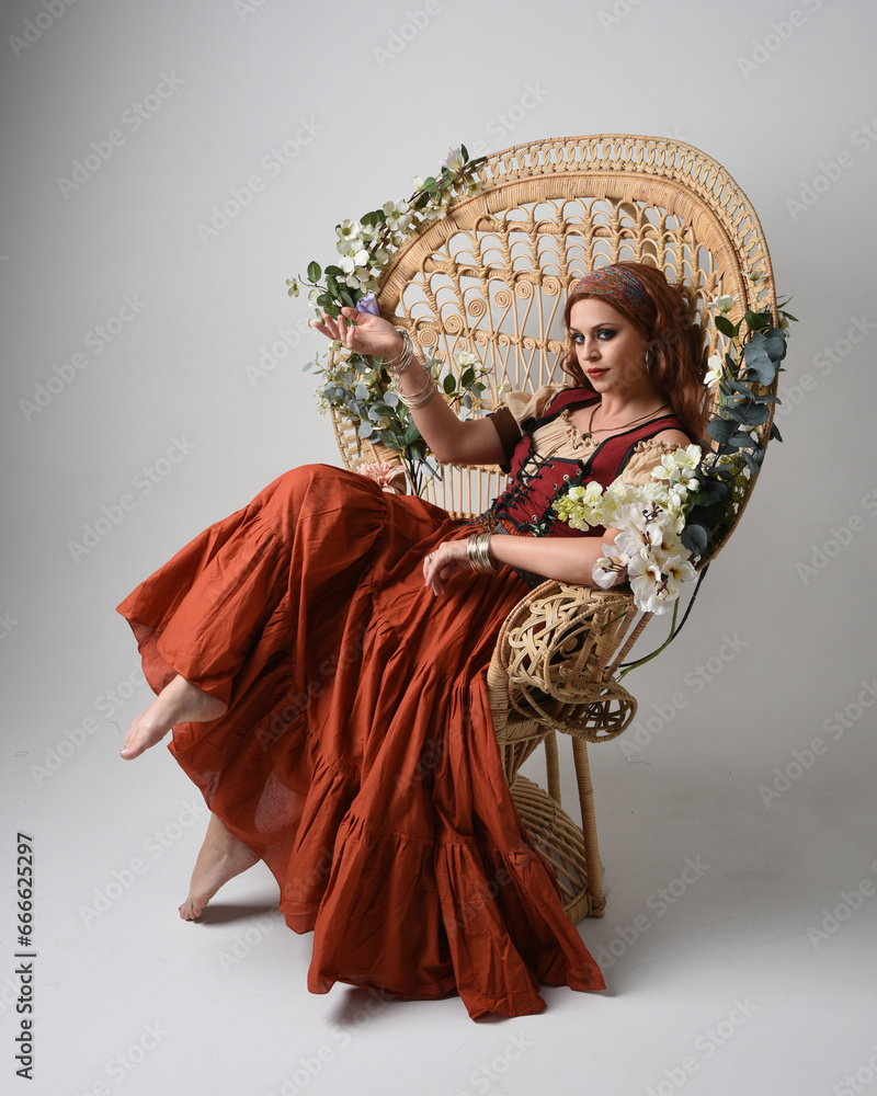 Full length portrait of beautiful red haired woman wearing a medieval ...