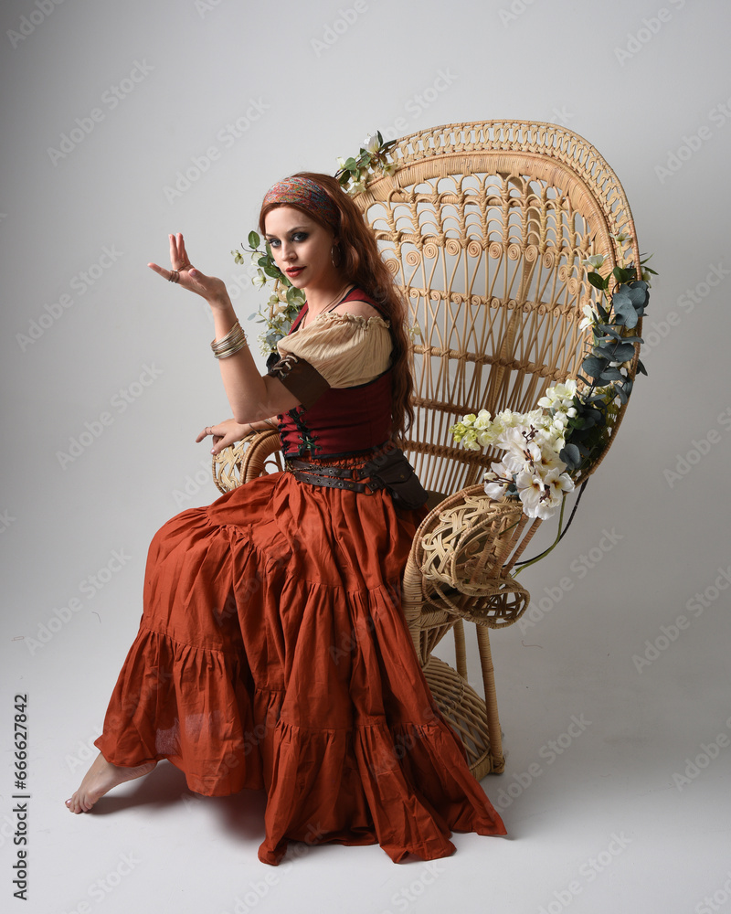 Full length portrait of beautiful red haired woman wearing a medieval ...
