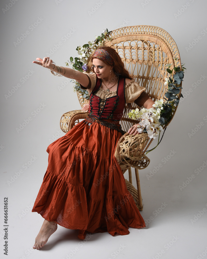 Full length portrait of beautiful red haired woman wearing a medieval ...