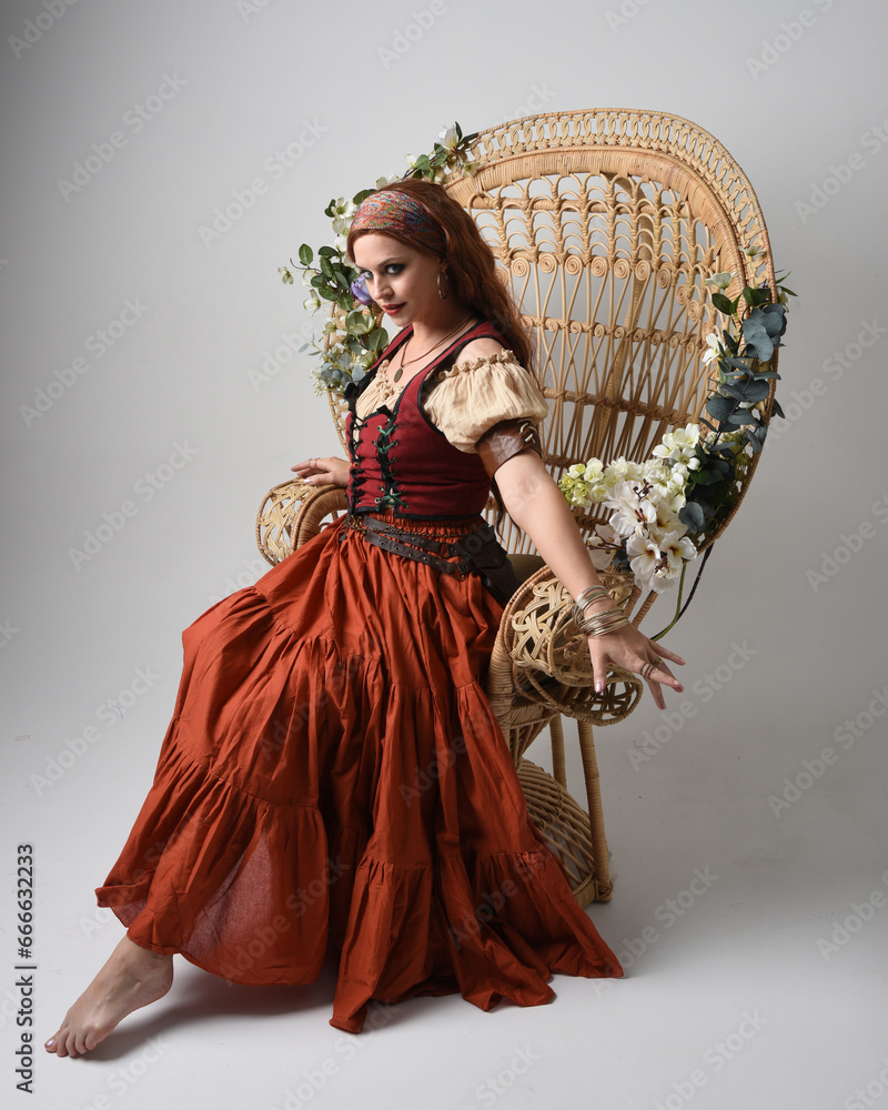 Full length portrait of beautiful red haired woman wearing a medieval ...