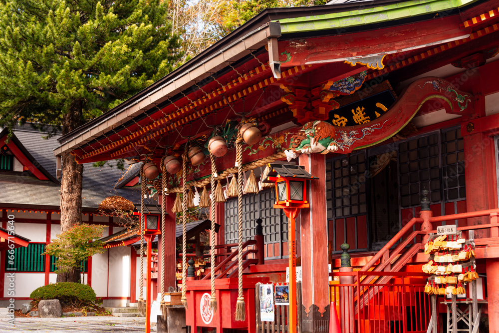 Suzu hanging under the eaves of a Shinto shrine in Japan Stock Photo ...