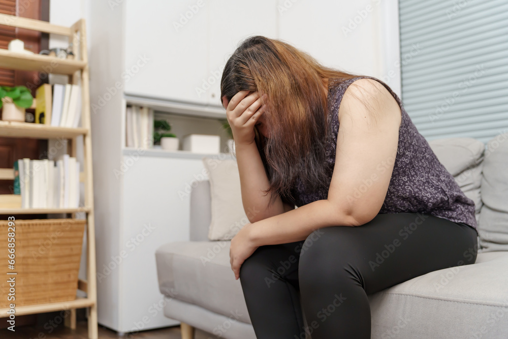 Sad Overweight plus size woman thinking about problems on sofa upset ...
