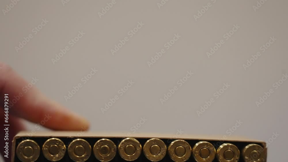 Rifle rounds to a .30-.30 caliber rifle being examined for defects ...