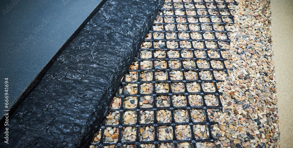 Creating a road surface for city streets. Layers of various materials ...