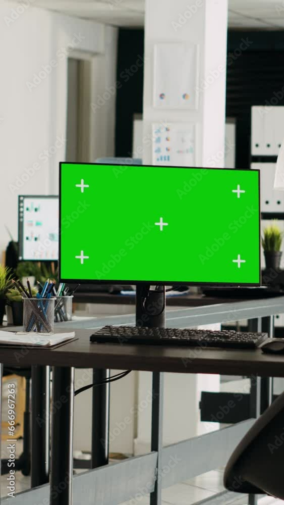 Vertical video Greenscreen monitor in coworking space running on desk ...