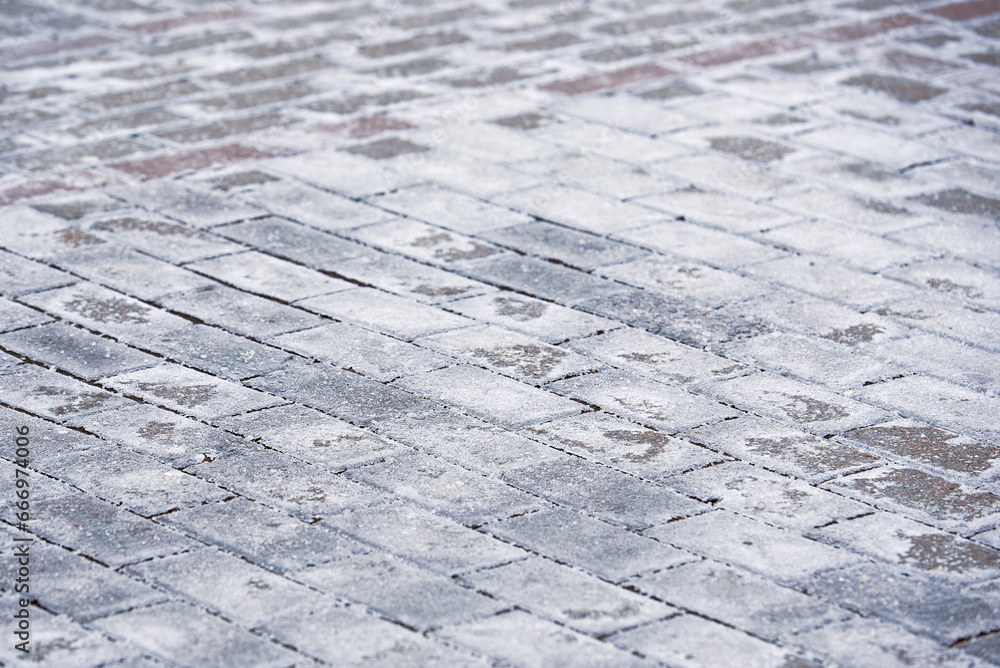 Salt stains on pedestrian paving slabs, salting sidewalk during winter ...
