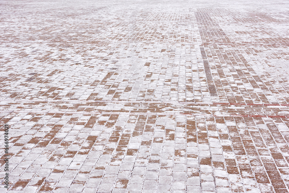 Salt stains on pedestrian paving slabs, salting sidewalk during winter ...