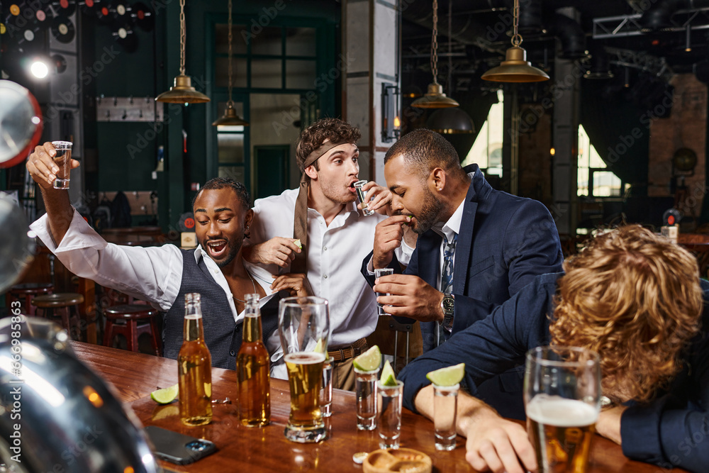 candid photo of funny and drunk multicultural men in formal wear ...