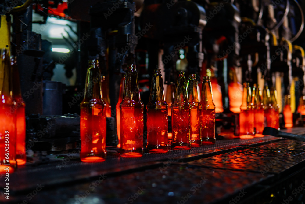 Production of glass bottles and glass containers. The heated glass ...