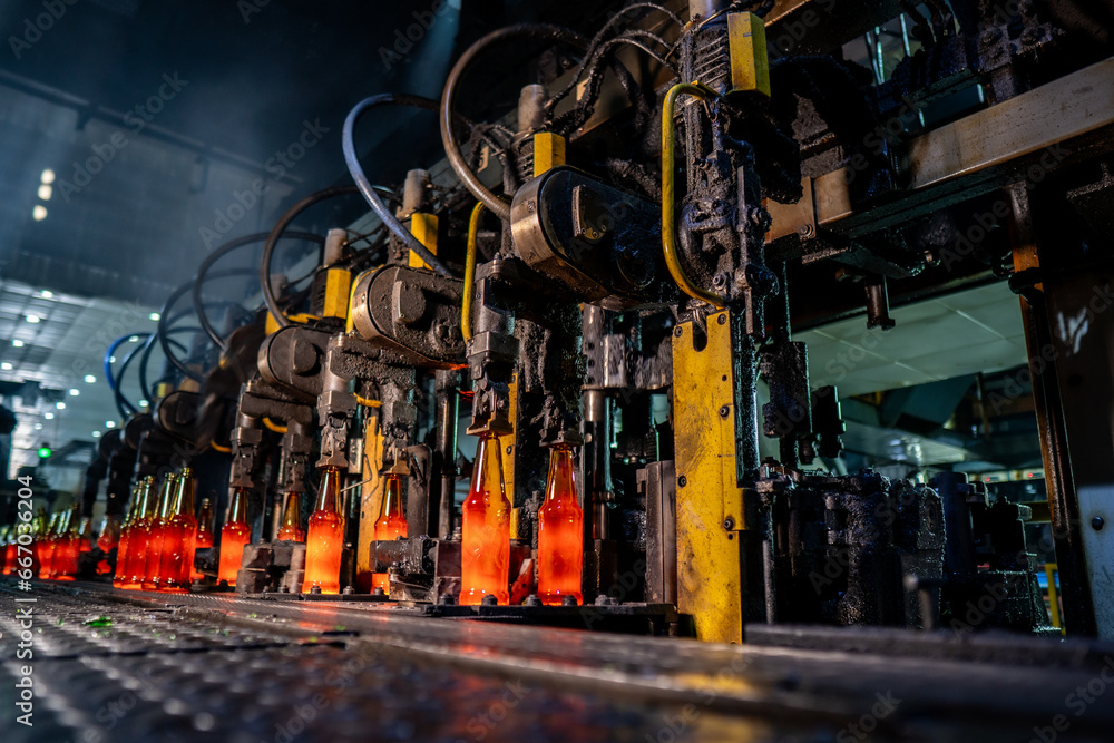 Production of glass bottles and glass containers. The heated glass ...