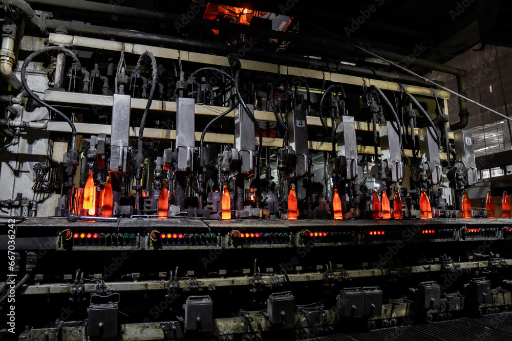 Production of glass bottles and glass containers. The heated glass ...