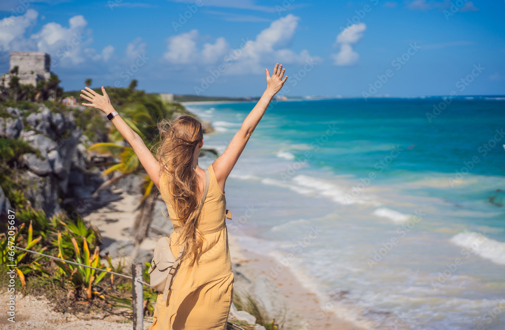 Woman tourist enjoying the view Pre-Columbian Mayan walled city of ...