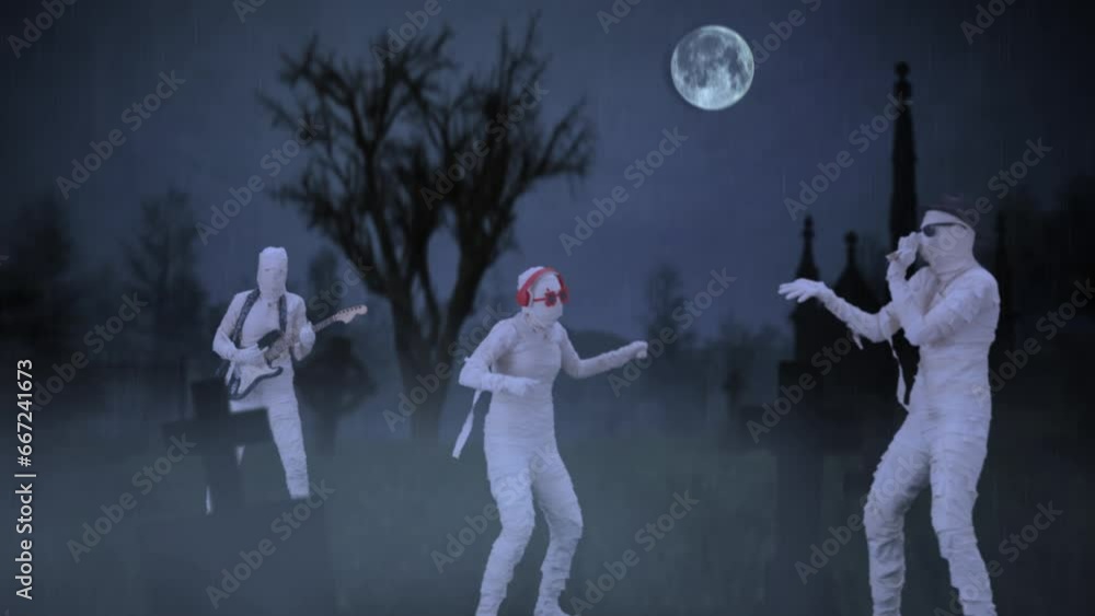 Dark, foggy and rainy graveyard filled with tombstones. Three mummies ...