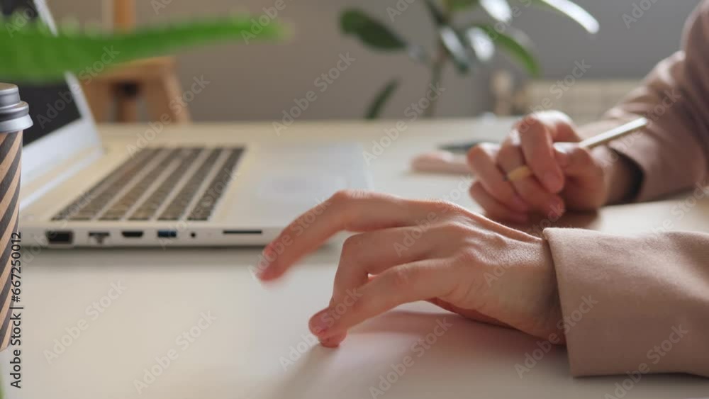 Unidentified female's hand nervously taping her desk with her fingers ...