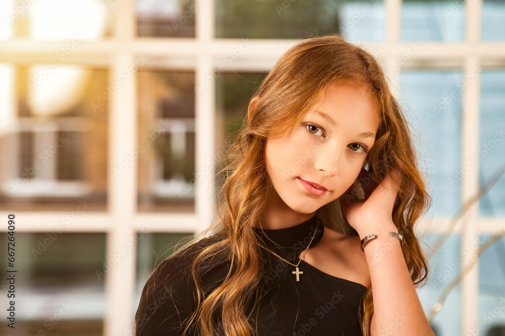 Face of perfect teen model girl 14 year old posing at large window ...