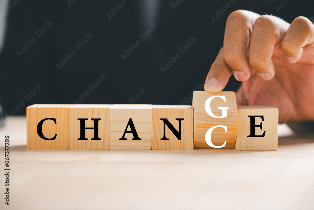 Hand of adult man flips wood block, revealing CHANCE from CHANGE ...