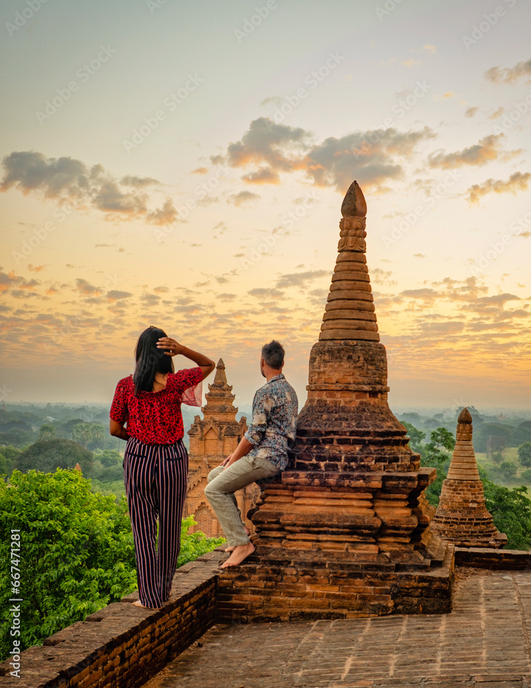 a couple visit Bagan Myanmar, Sunrise above temples and pagodas of ...